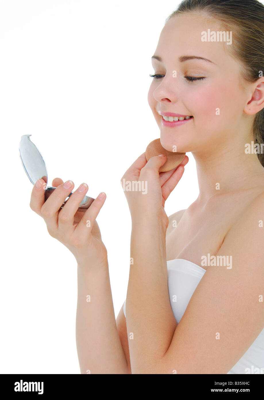Young woman applying face powder and smiling Stock Photo - Alamy