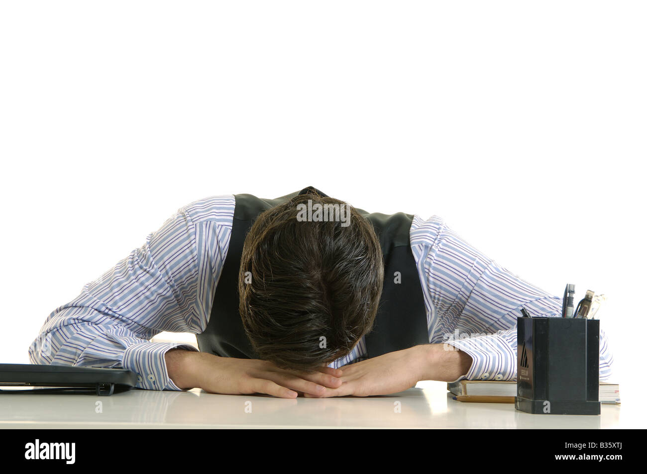 Businessman napping on a desk in an office Stock Photo - Alamy