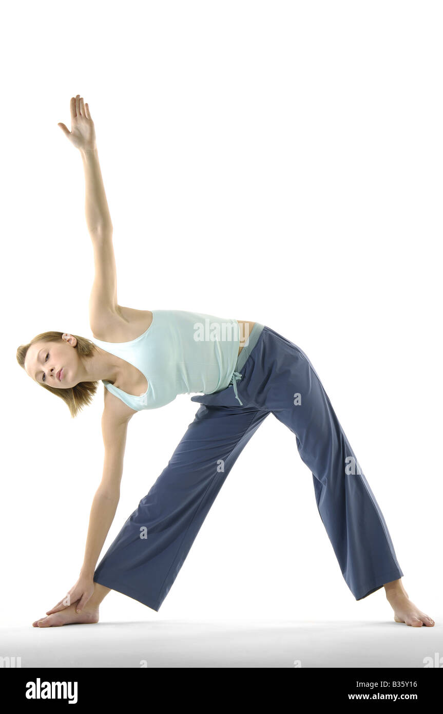 Young woman standing in triangle position Stock Photo - Alamy