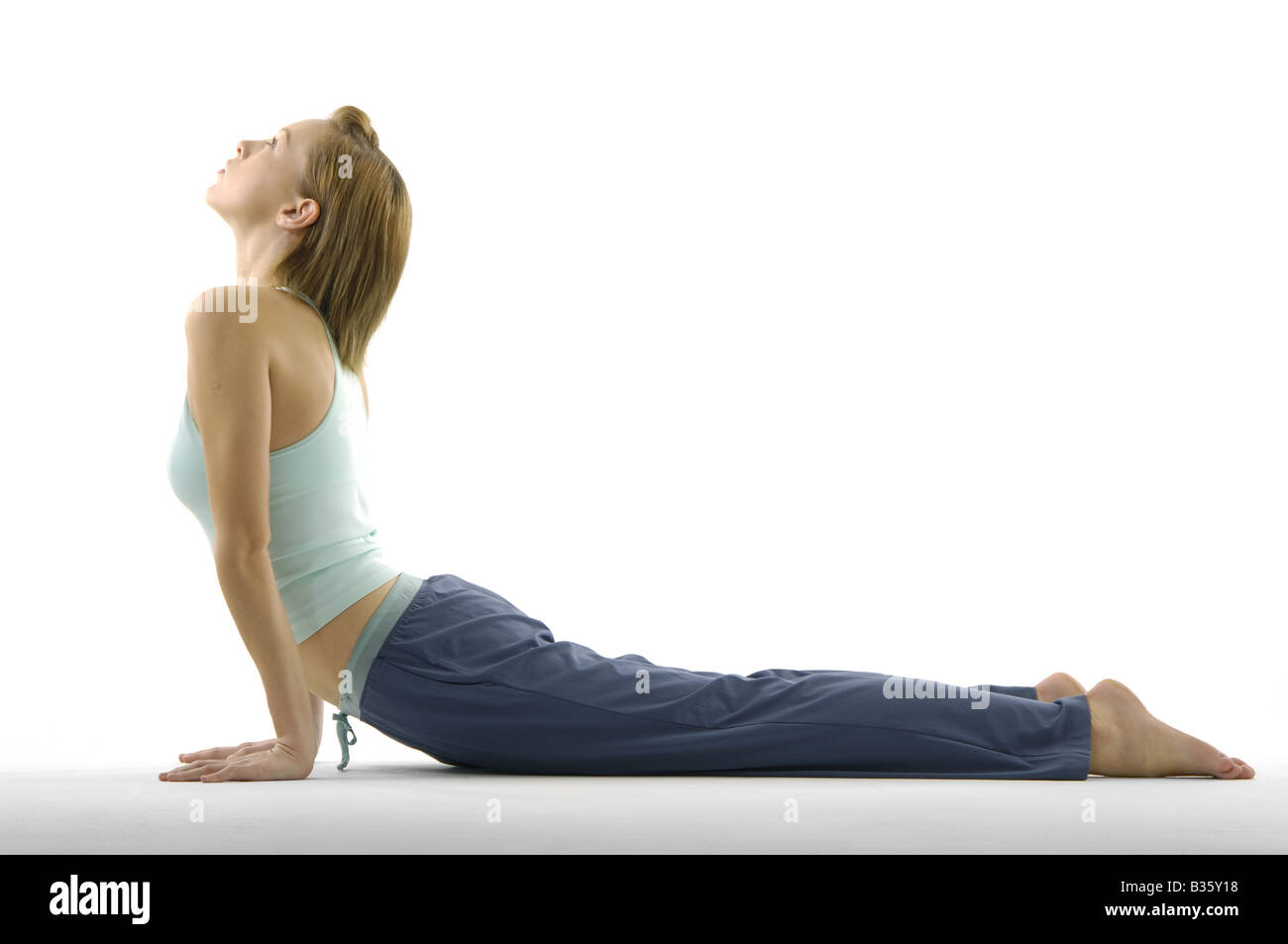 Young woman lying in cobra pose Stock Photo - Alamy