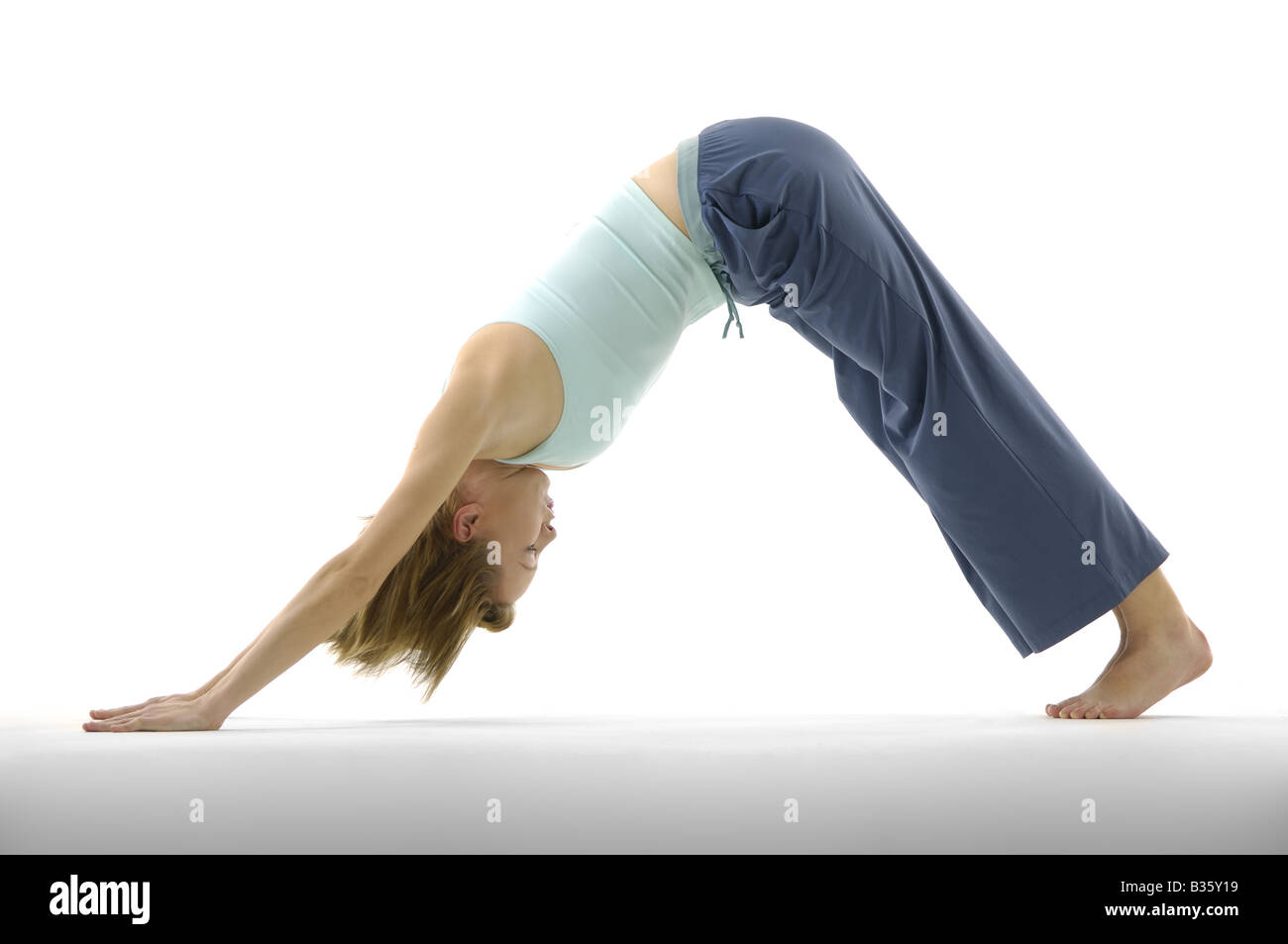 Young woman in downward facing dog position Stock Photo - Alamy