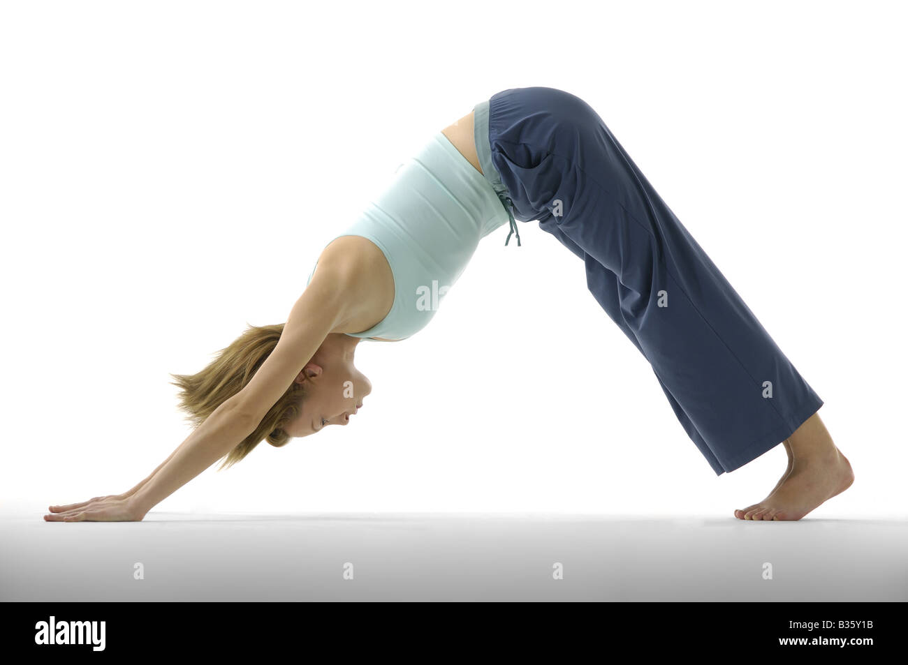 Side profile of a young woman in downward facing dog position Stock ...
