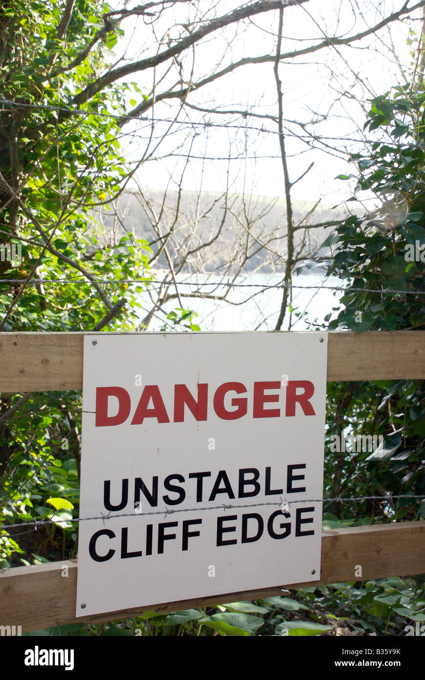 Danger notice unstable cliff edge, Salcombe, Devon, UK Stock Photo - Alamy