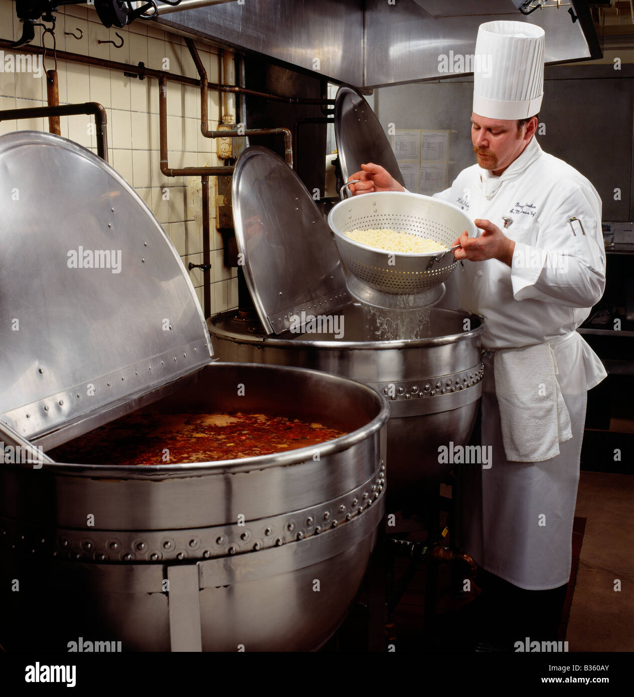 Sous chef cooks pasta in an upscale hotel/resort commercial kitchen ...