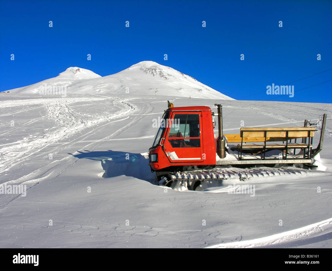 The red snowmobile frozen in a snow Stock Photo - Alamy