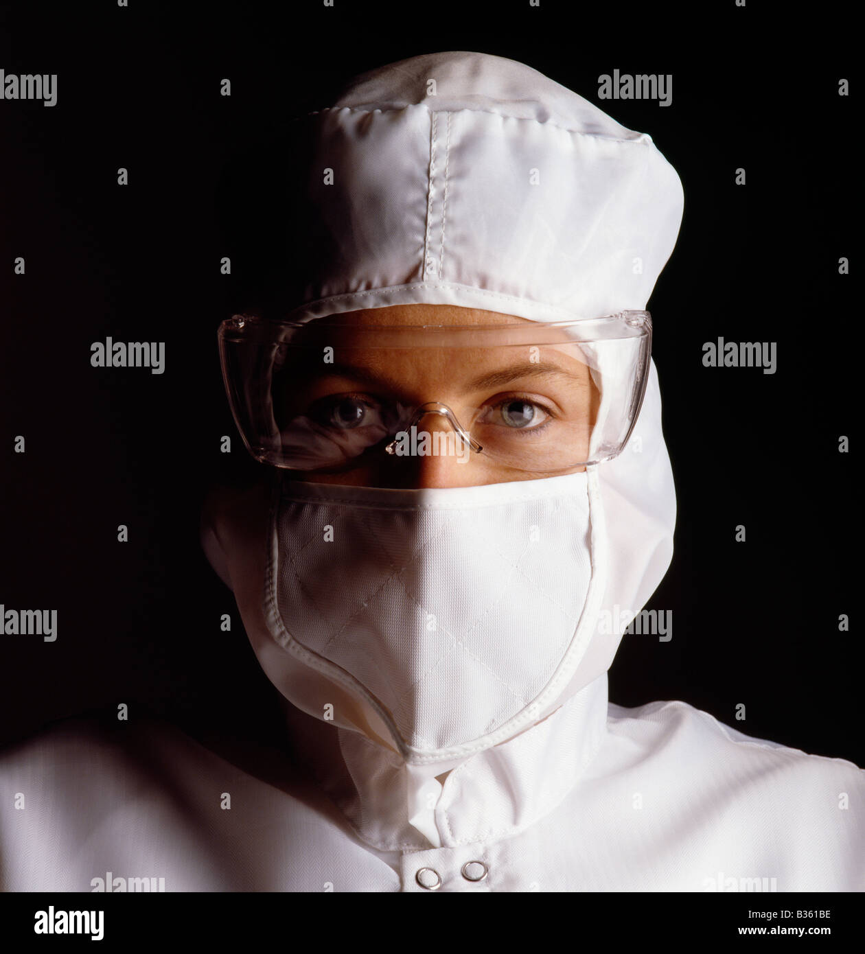 Female technician dressed in special low static outfit worn during the ...