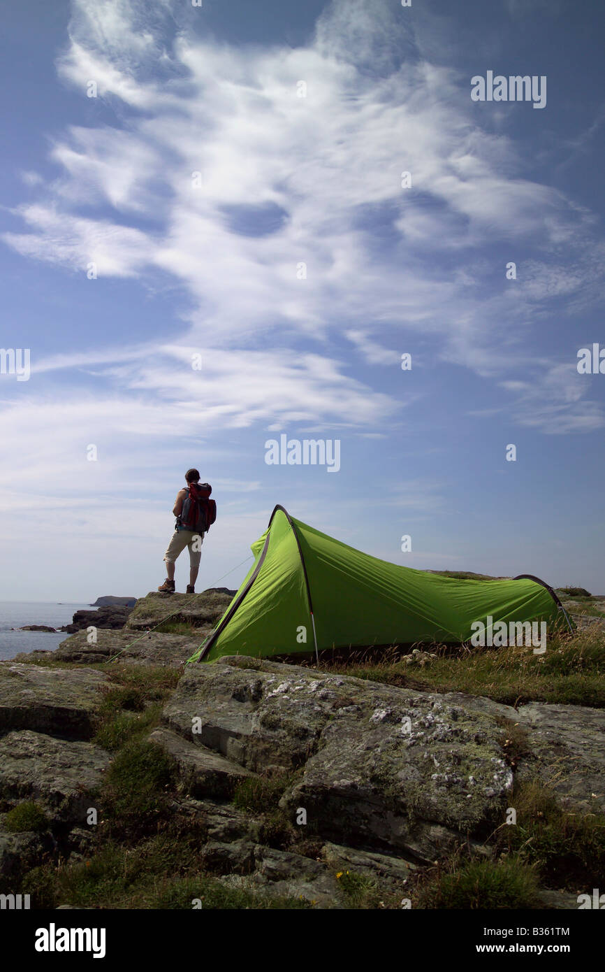 Green tent on cliff top overlooking the Sea with walker Stock Photo - Alamy
