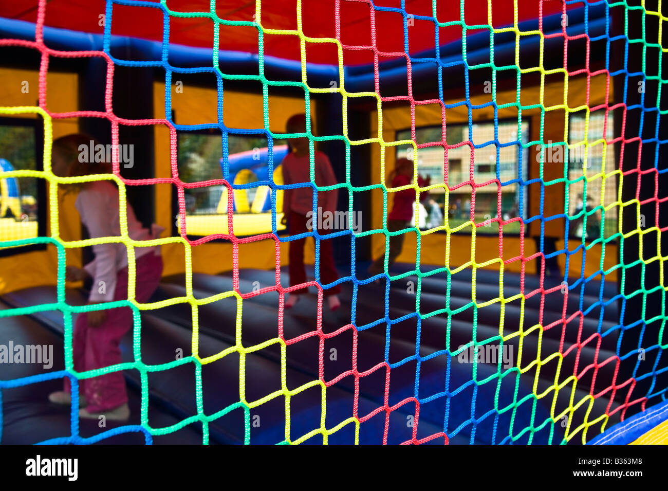 Net in front of bouncy game Stock Photo - Alamy