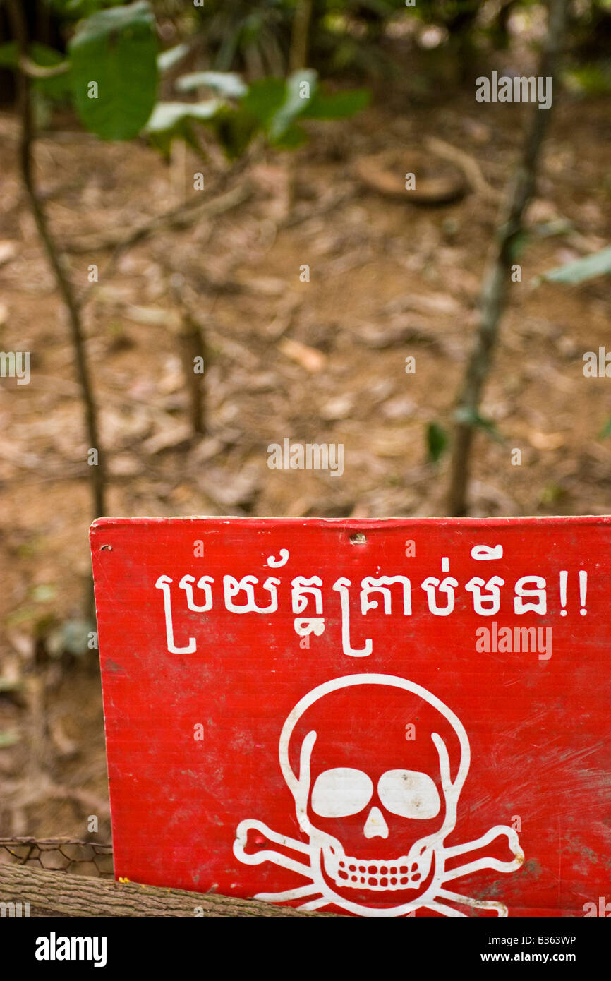 Red skull and crossbones landmine warning sign with Cambodian Khmer ...