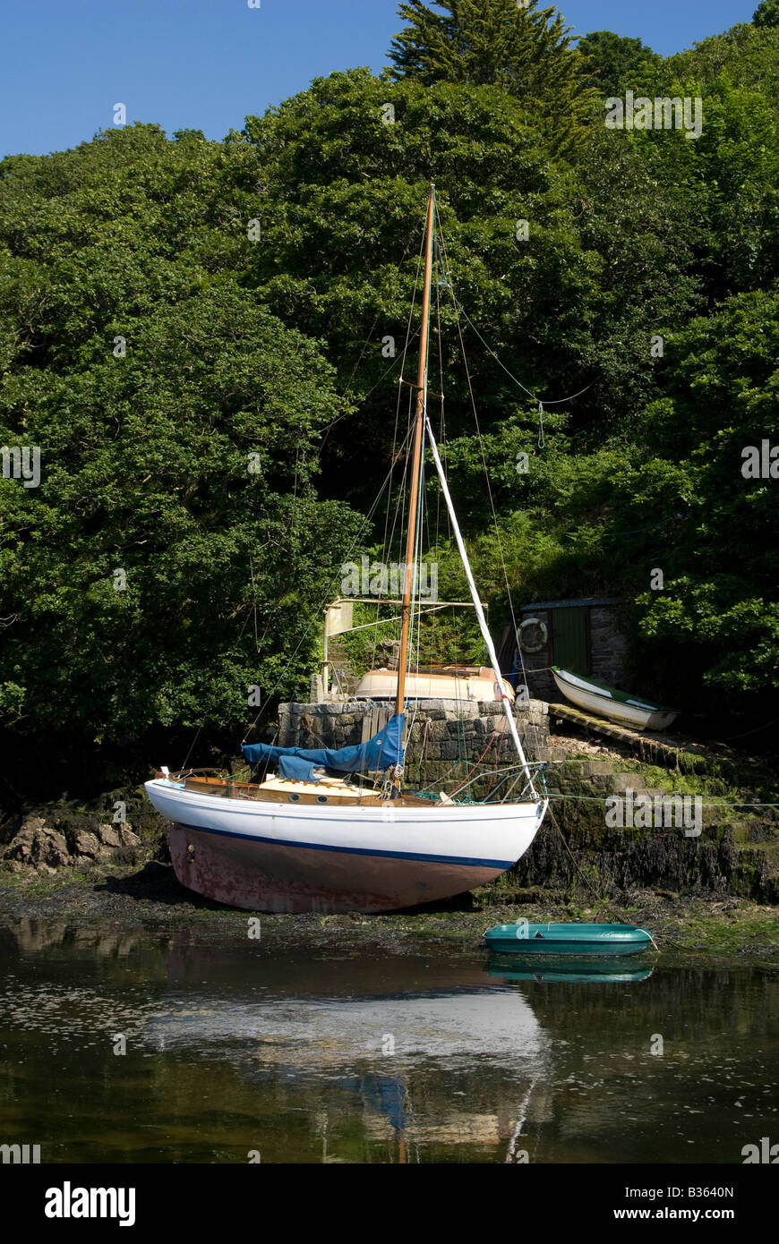 Yacht drying on a mud berth in Gillan Creek, off the Helford River, St ...
