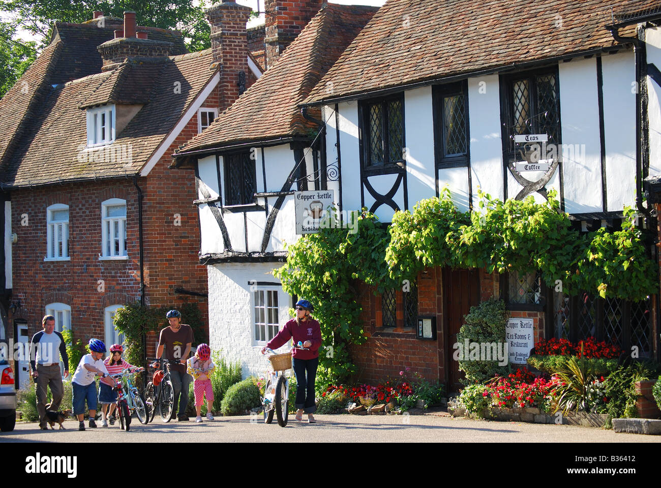 Family on bicycles, Chilham Square, Chilham, Kent, England, United ...