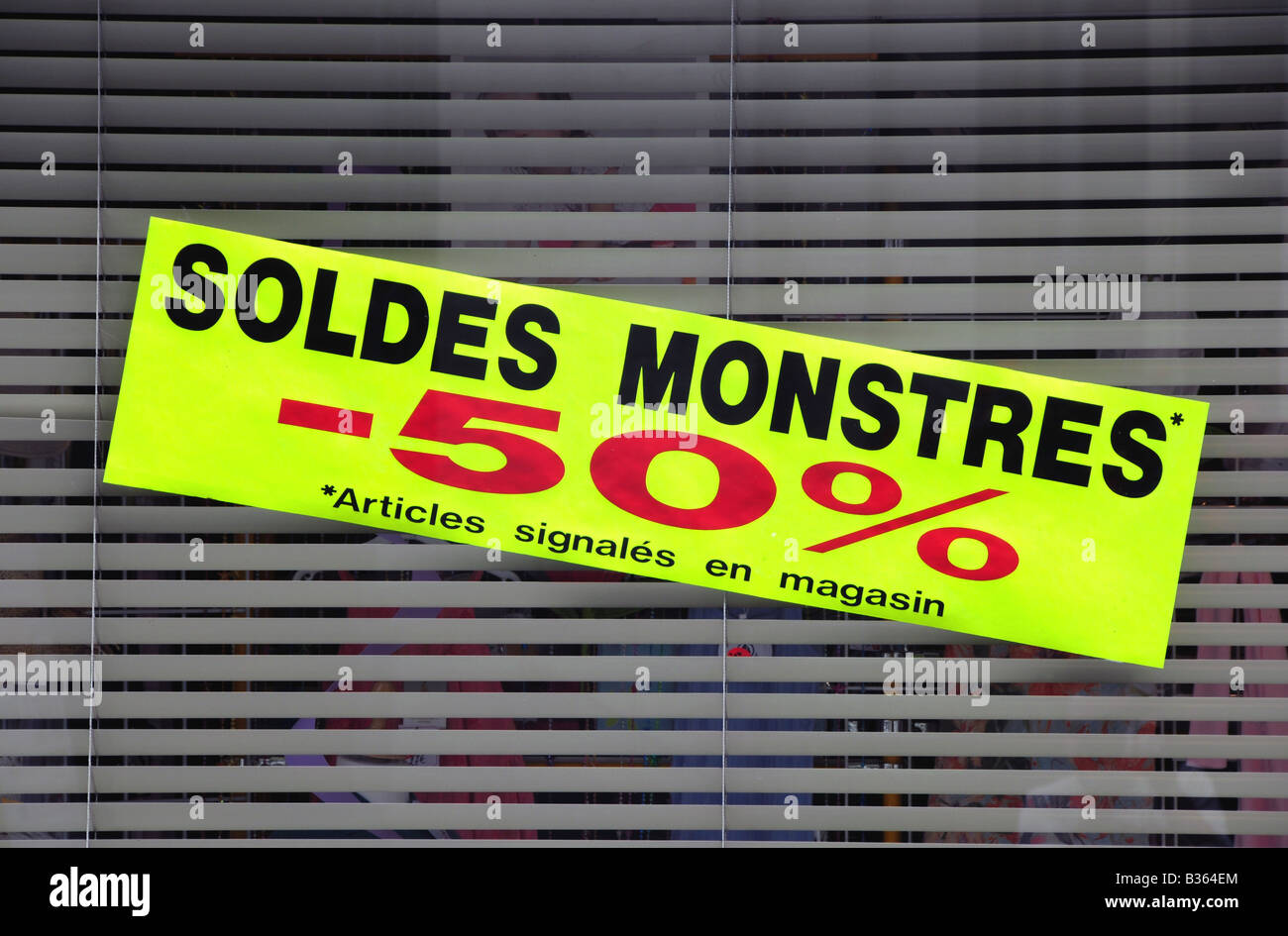 Sale sign in a French shop window Stock Photo - Alamy