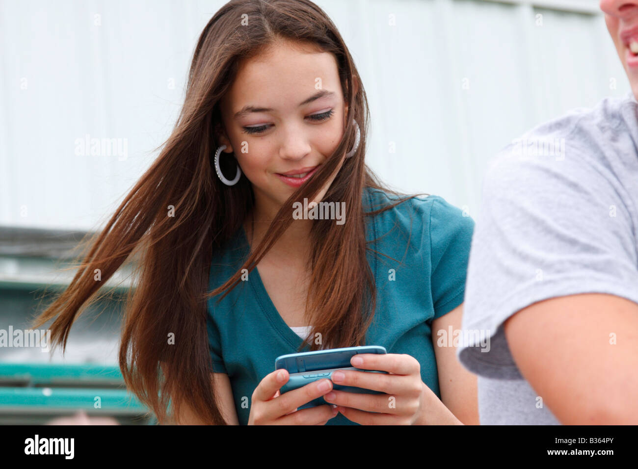 Student checking text messages at school stadium Stock Photo - Alamy Student checking text messages at school stadium Stock Photo - Alamy
