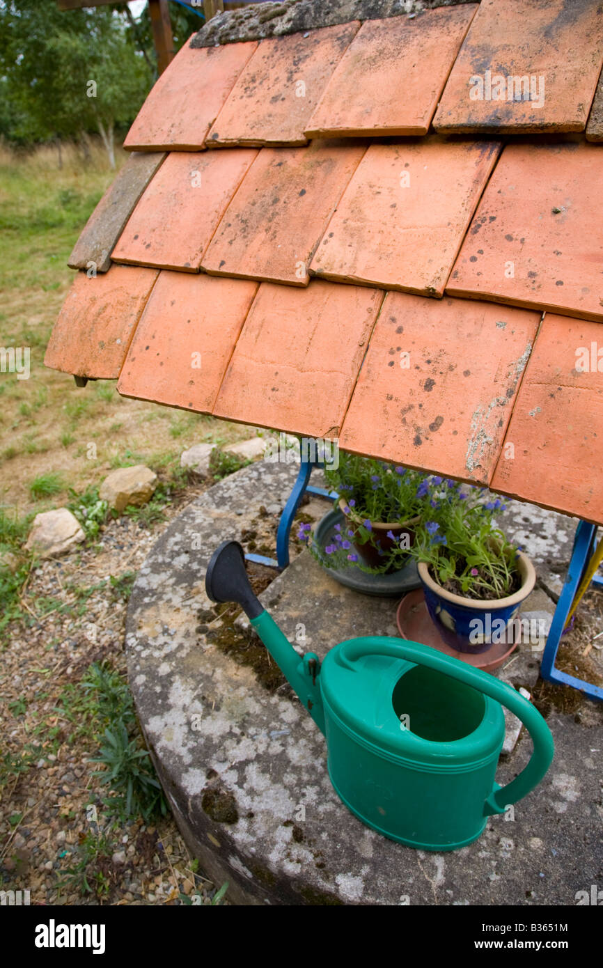 Covered well tiled in traditional terracotta tiles Stock Photo - Alamy