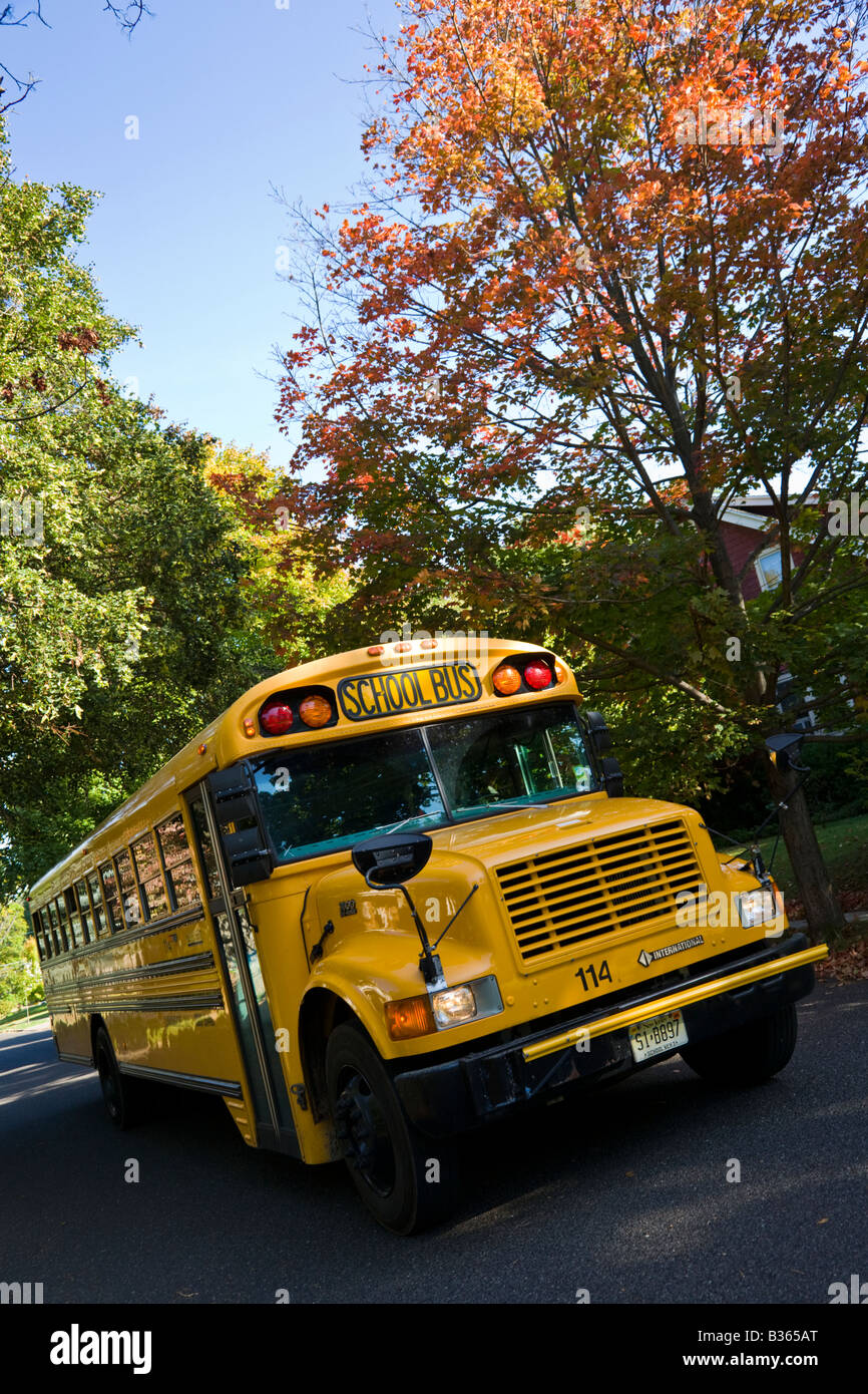 School bus driving down the road Stock Photo - Alamy
