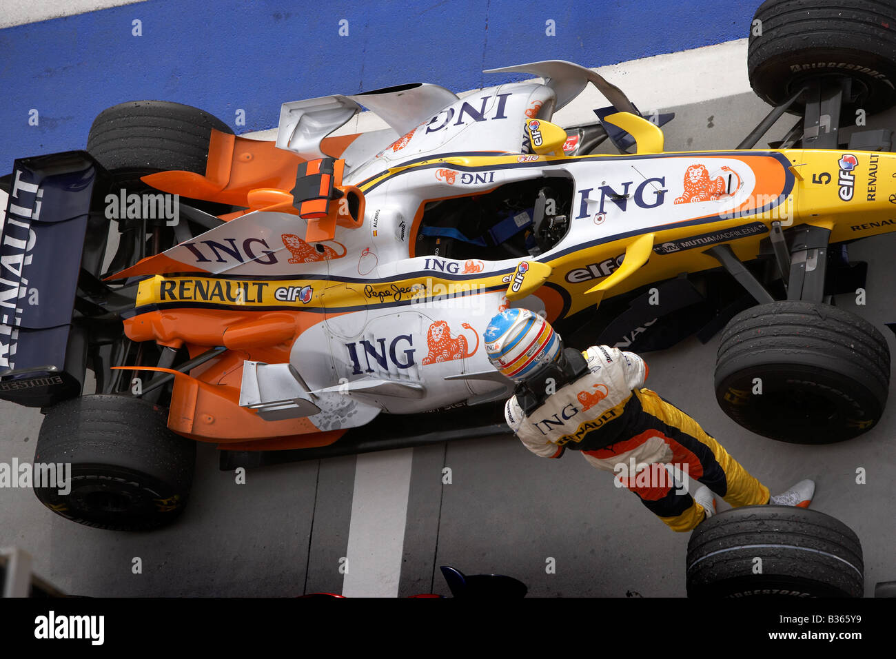 Fernando Alonso for Renault inspects his car after finishing 10th in ...