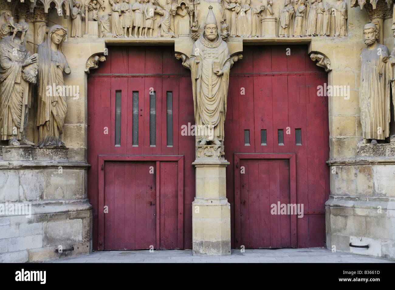 Reims, France. Embossments, statues and Brown/Red doors at the famous ...