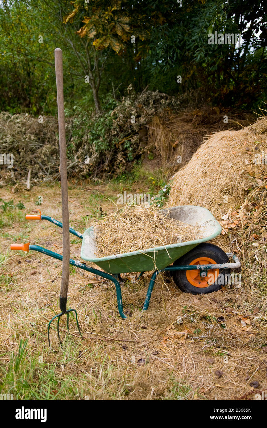 Haystack, fork, and wheel barrow Stock Photo - Alamy