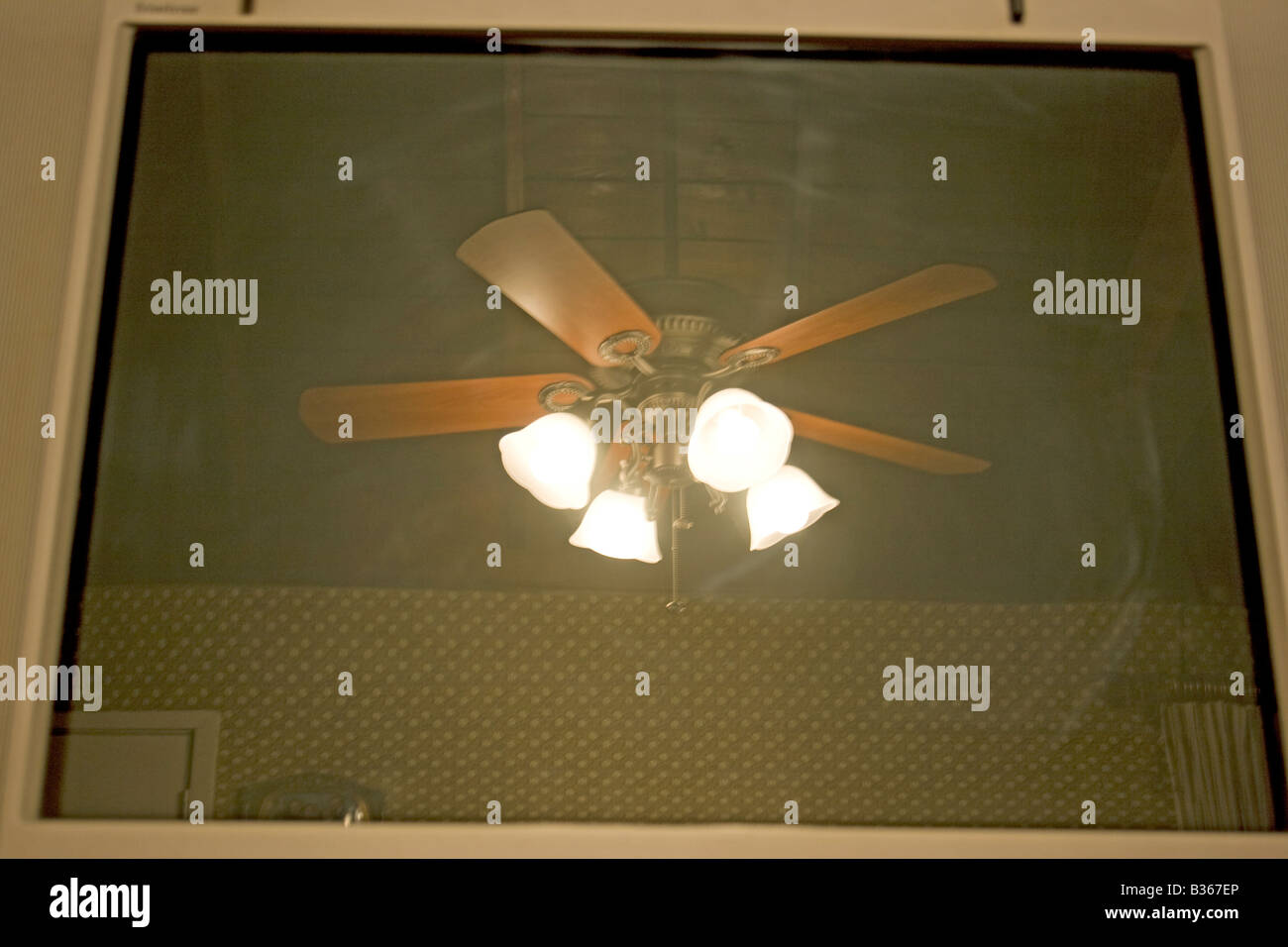 Reflection of ceiling Light and fan in TV Stock Photo - Alamy
