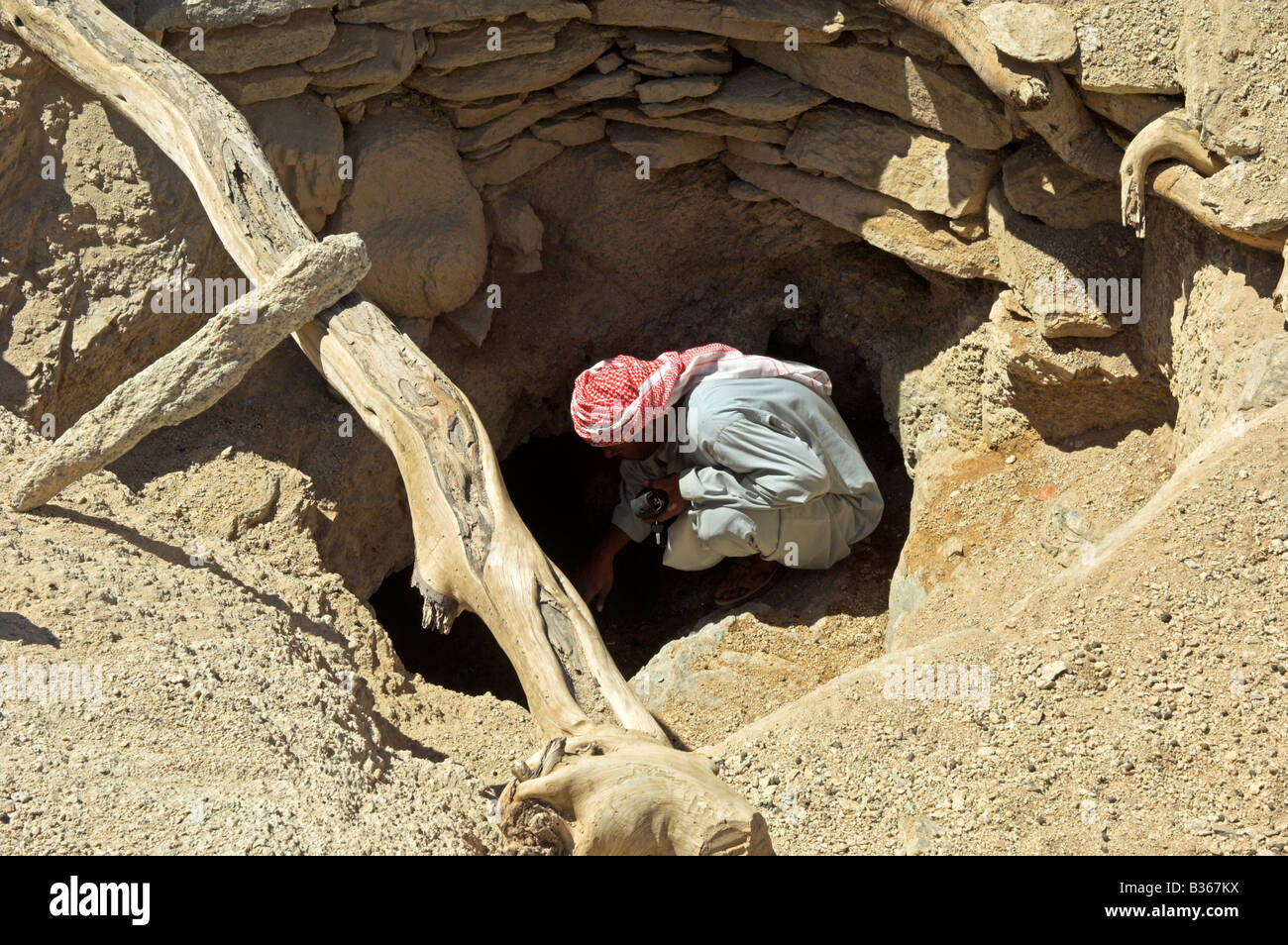 Ababda Bedouin tribesman in desert deep [water hole] Wadi El Gemal ...