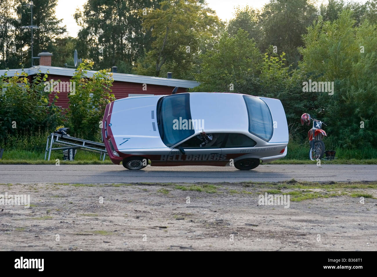 BMW car on 2 wheels stunt Stock Photo - Alamy