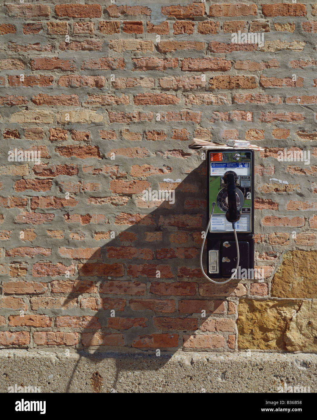 Public phone on wall Stock Photo - Alamy