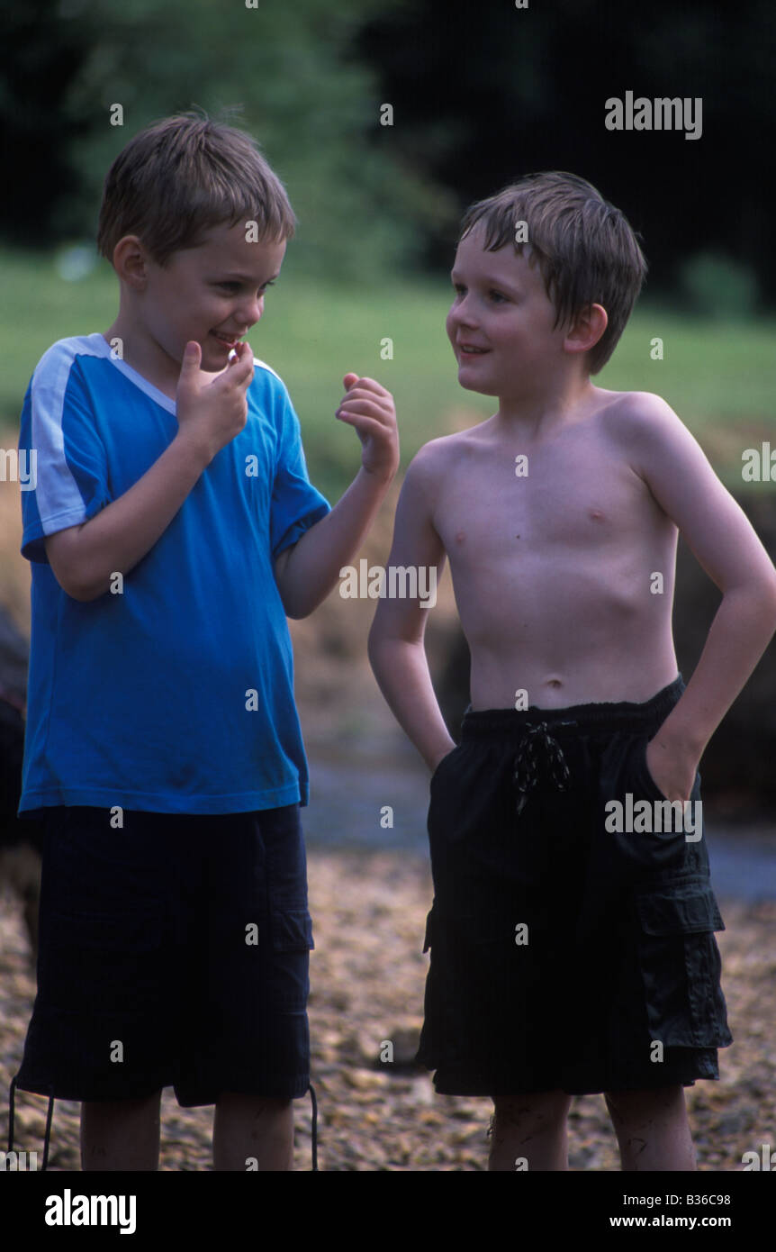 two boys chatting and playing together Stock Photo - Alamy