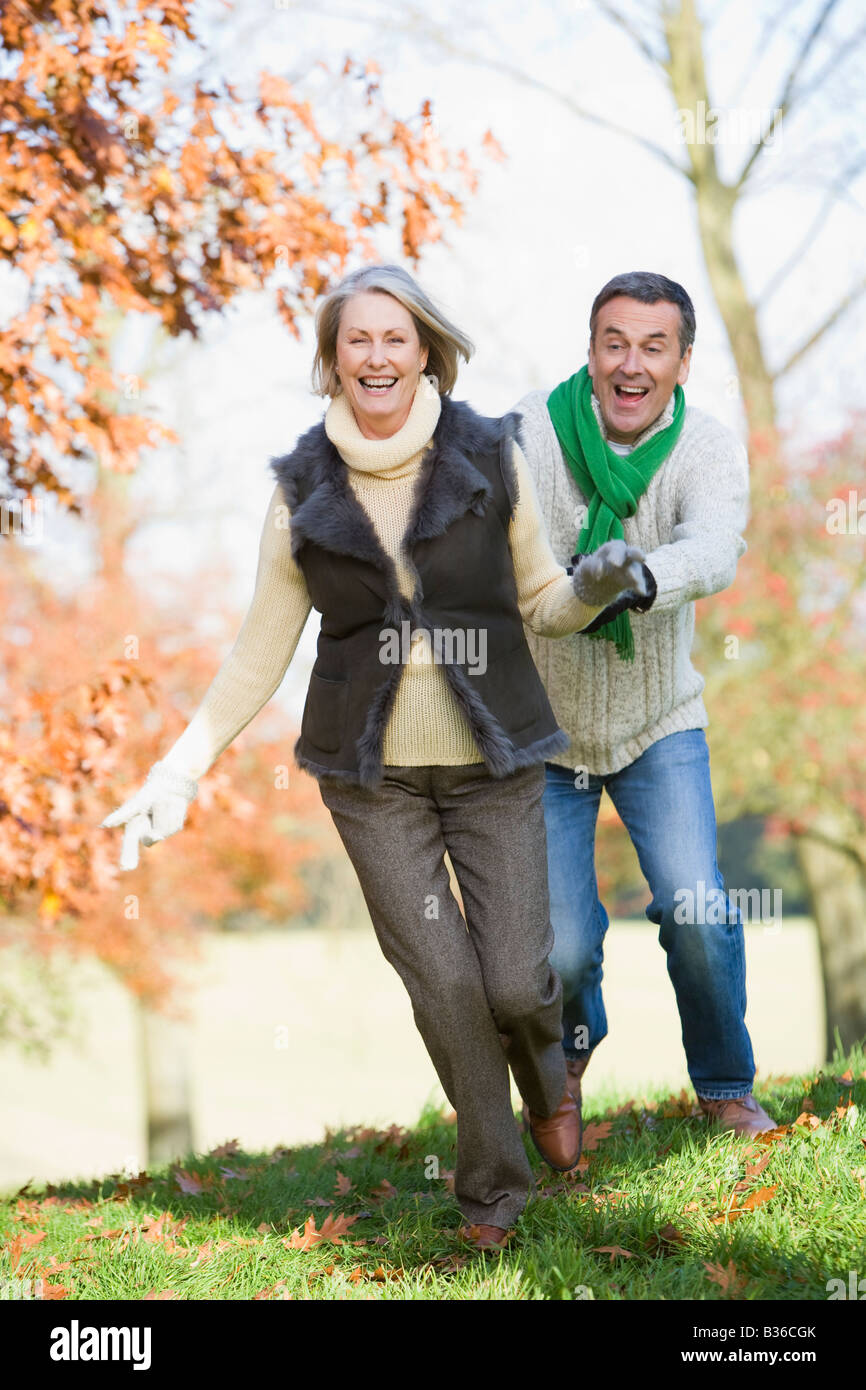 Young woman running around tree hi-res stock photography and images - Alamy