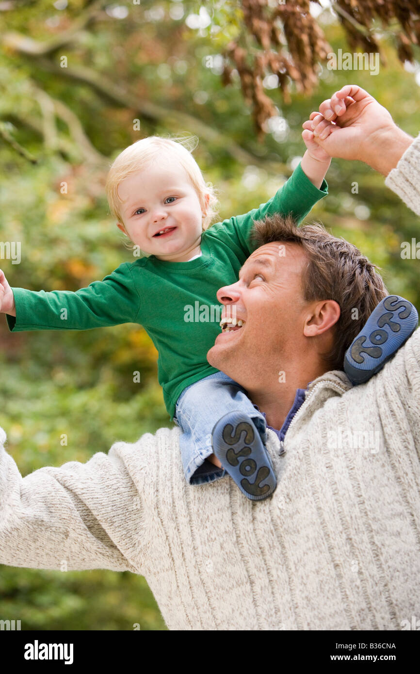 Father giving baby son piggyback Stock Photo - Alamy
