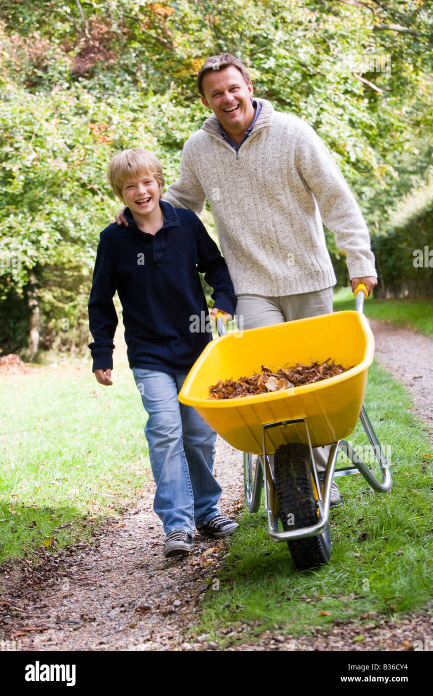 Man with wheelbarrow hi-res stock photography and images - Alamy