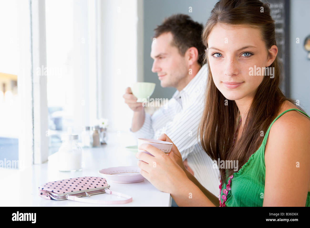 Young couple having tea in a cafeteria Stock Photo - Alamy