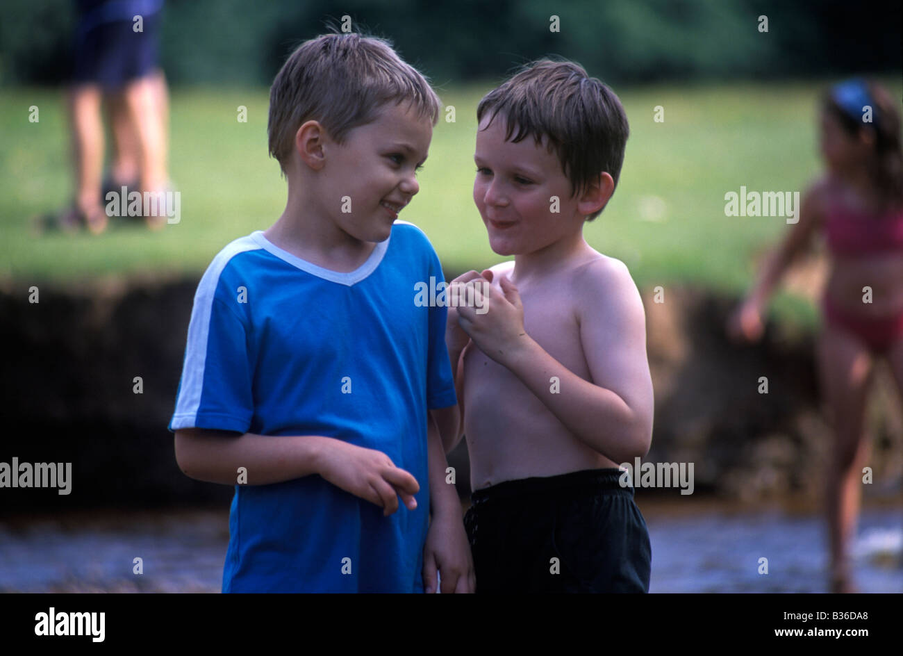 two boys chatting and playing together Stock Photo - Alamy