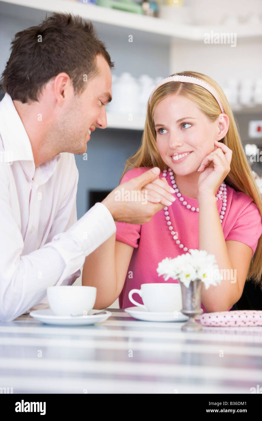 Young couple having tea in a cafeteria Stock Photo - Alamy