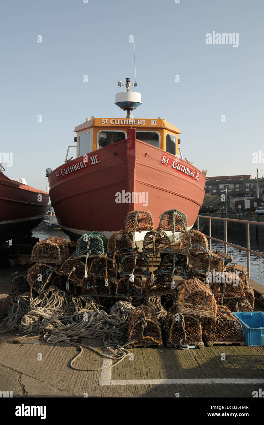 Fishing boat, lobster pots and crab pots on the quayside at Seahouses ...