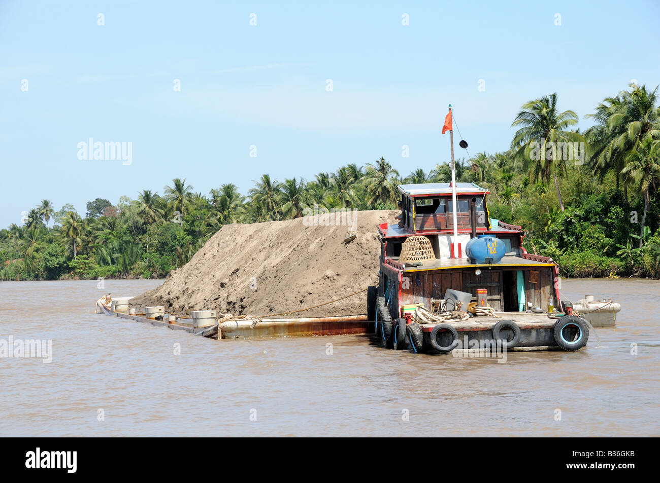 Sand dredging on the Mekong River to keep the waterway sand and stilt ...