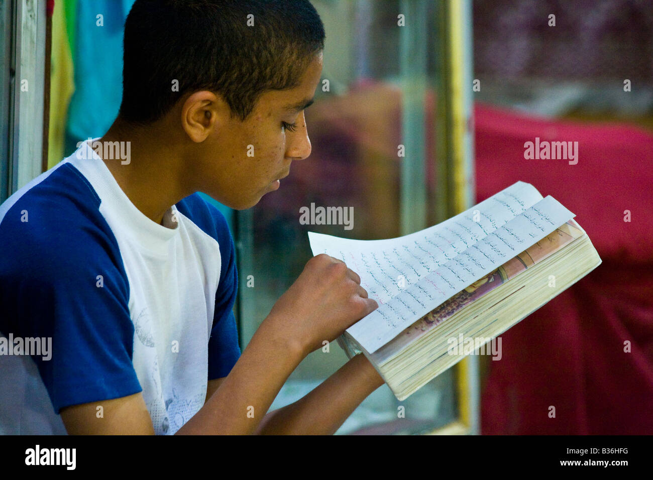 Iranian Boy Reading a Book in Arabic in Regents Bazaar in Kerman Iran ...