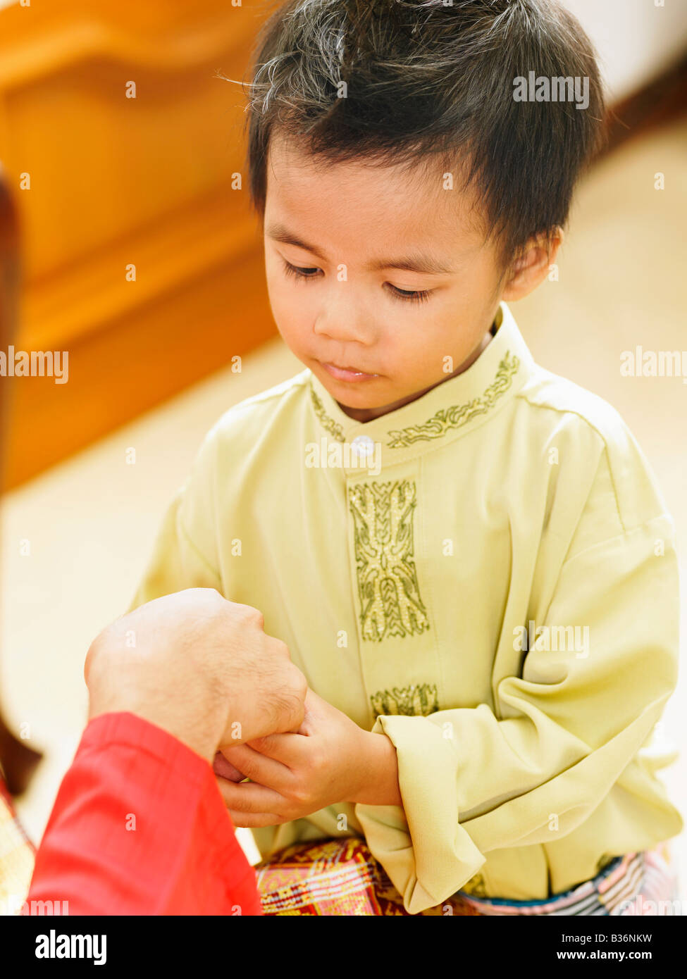 Little boy looking at hand Stock Photo - Alamy