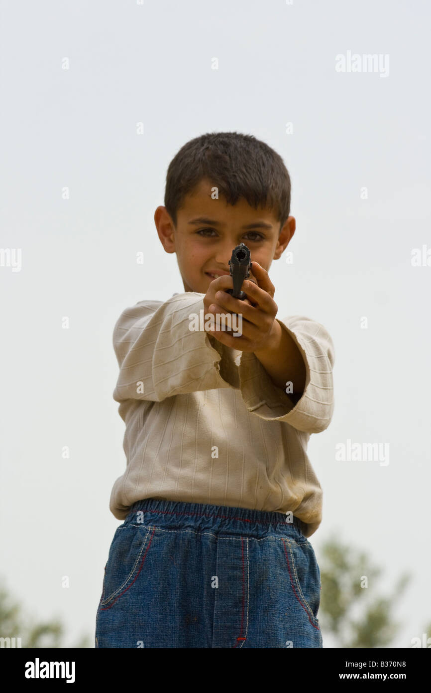 Boy playing plastic toy gun hi-res stock photography and images - Alamy