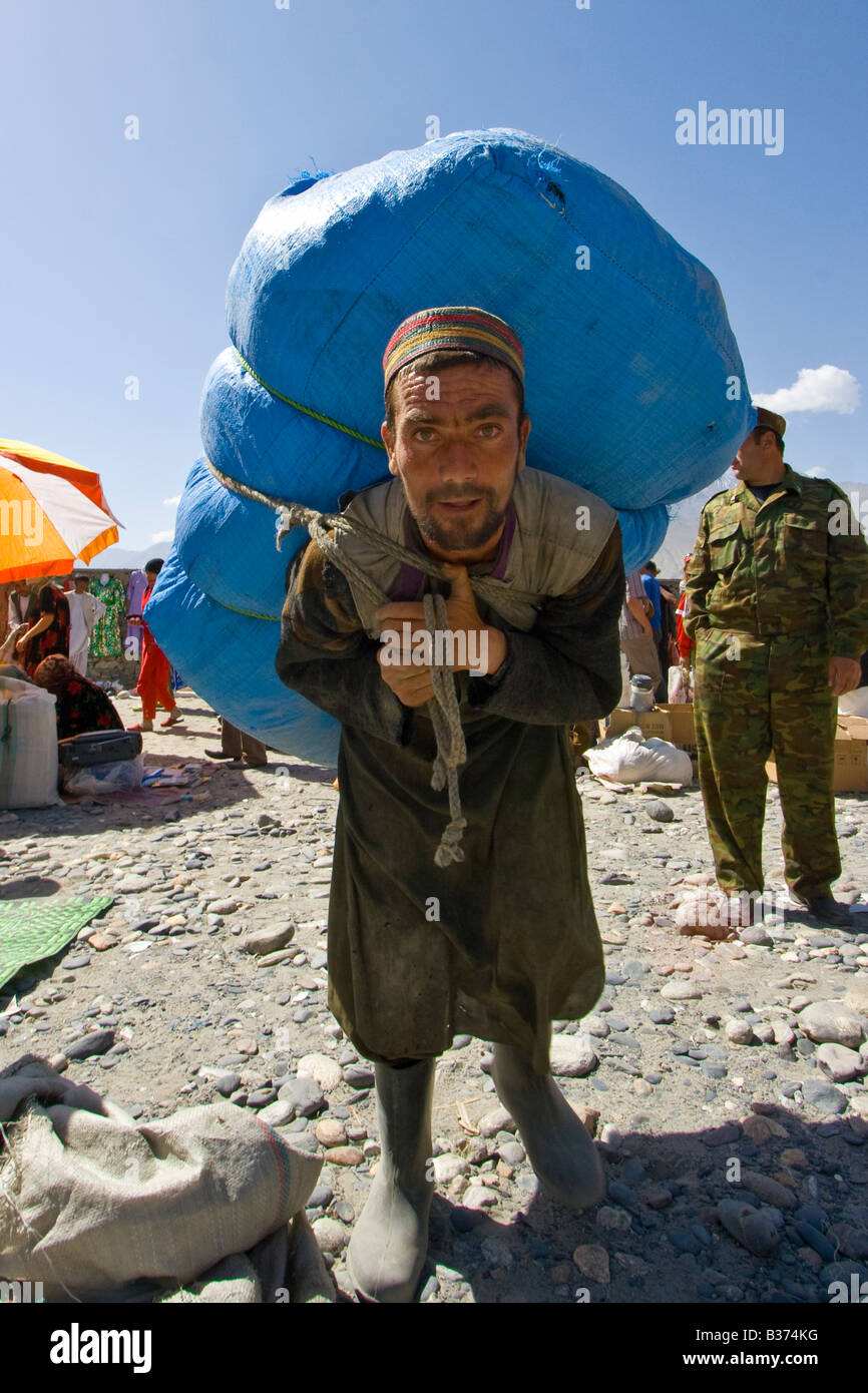 Afghan Man Carrying Goods To Sell At The Cross Border Market Between