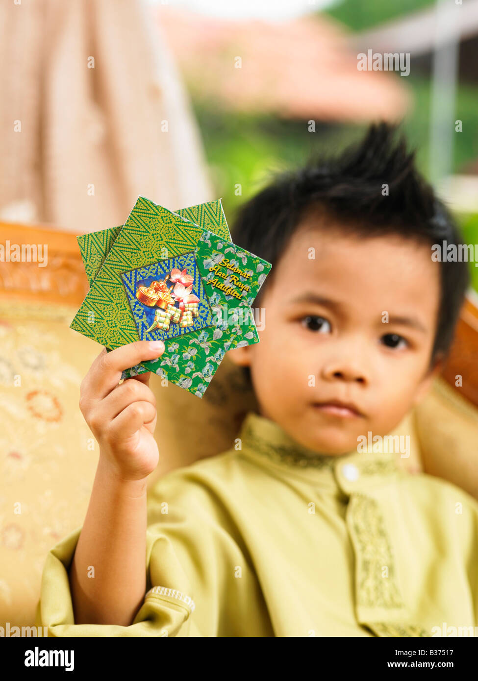 Boy displaying his green packet Stock Photo - Alamy