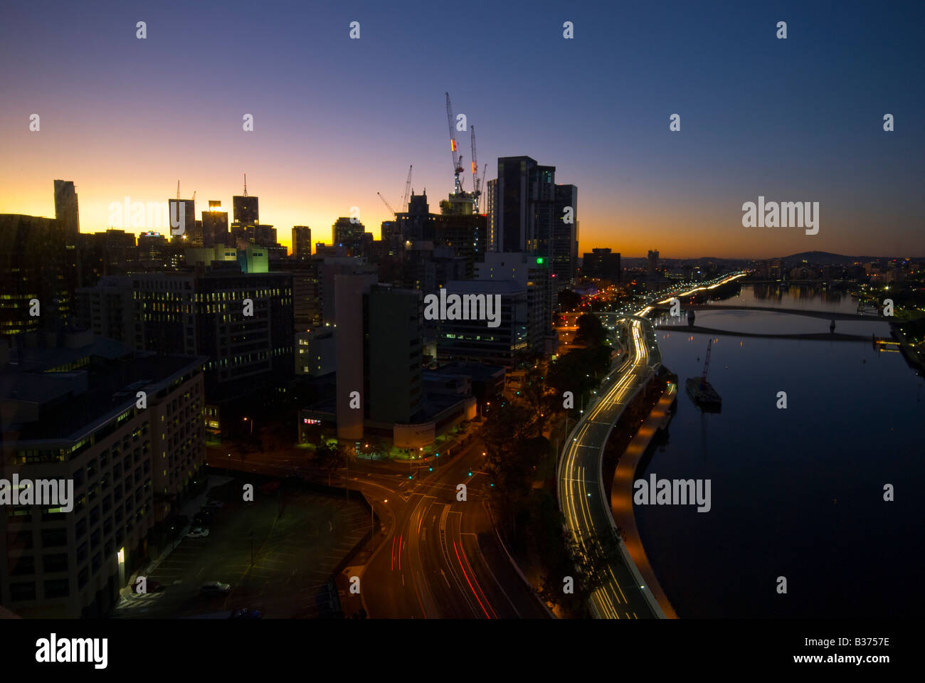 Brisbane city skyline along the Brisbane River at sunrise Stock Photo ...