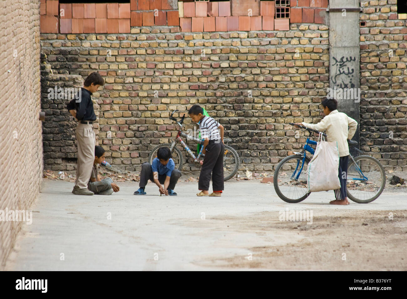 People children boys playing marbles hi-res stock photography and ...