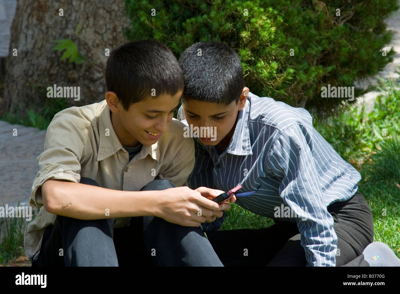 Two Boys Using Features on a Mobile Phone in Kerman Iran Stock Photo ...