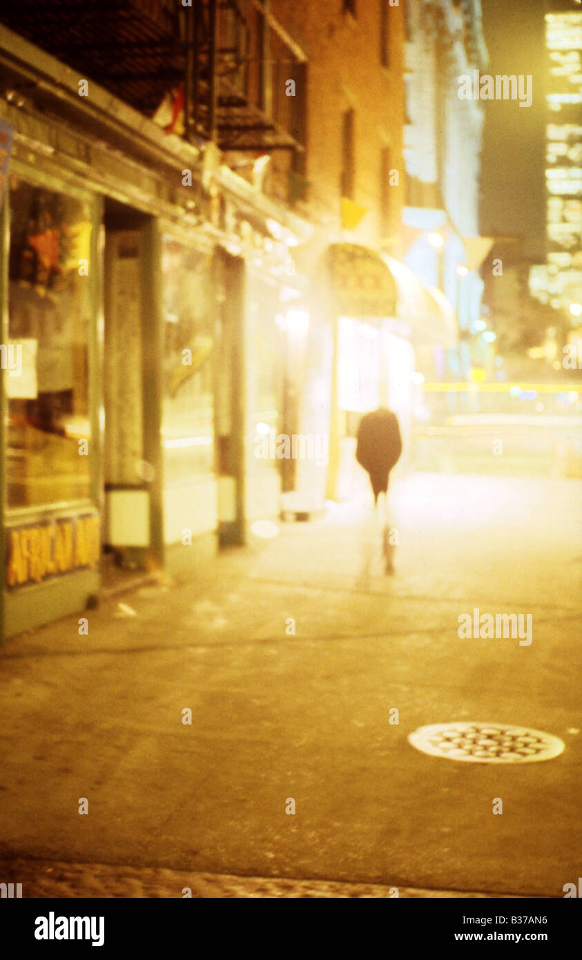 mysterious night shot of city at night with strange figure of man in ...