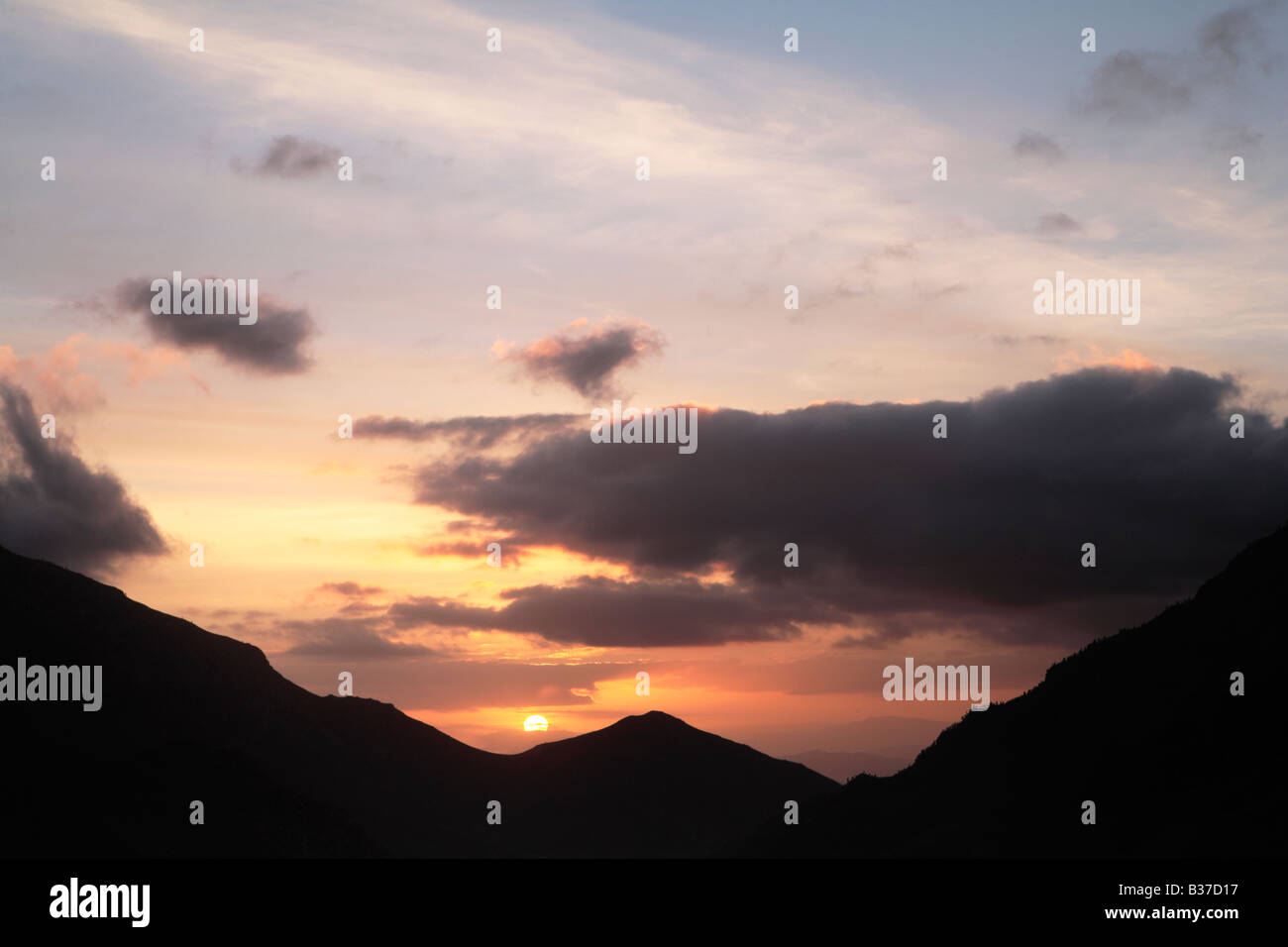 Sunset over mountain Stock Photo - Alamy