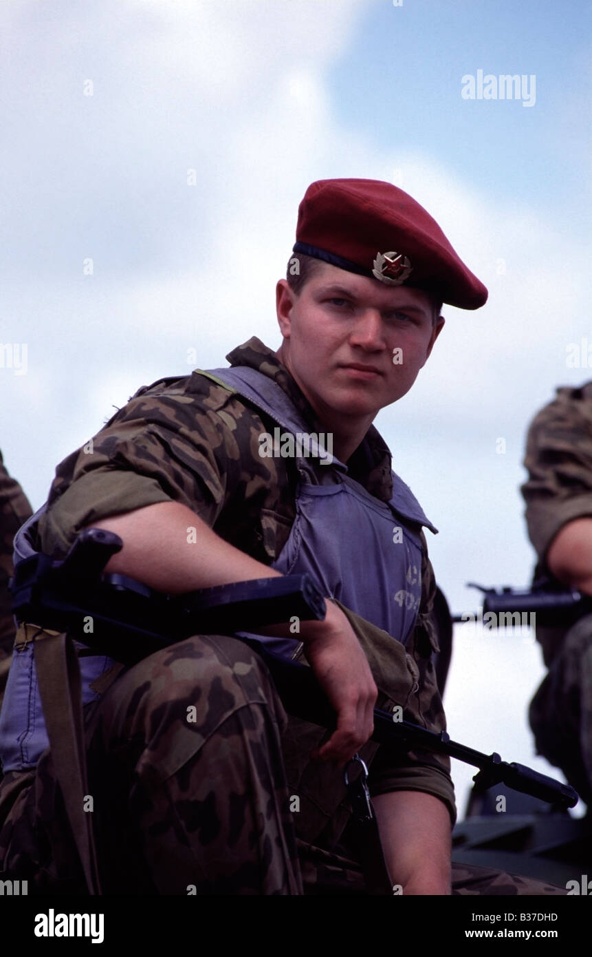 Russian Soldier with Kalashnikov and bullet proof vest sits on a ...