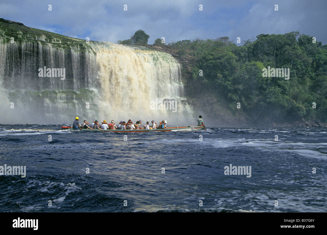 Visitors in a dugout canoe in the Caroni River in Canaima National park ...