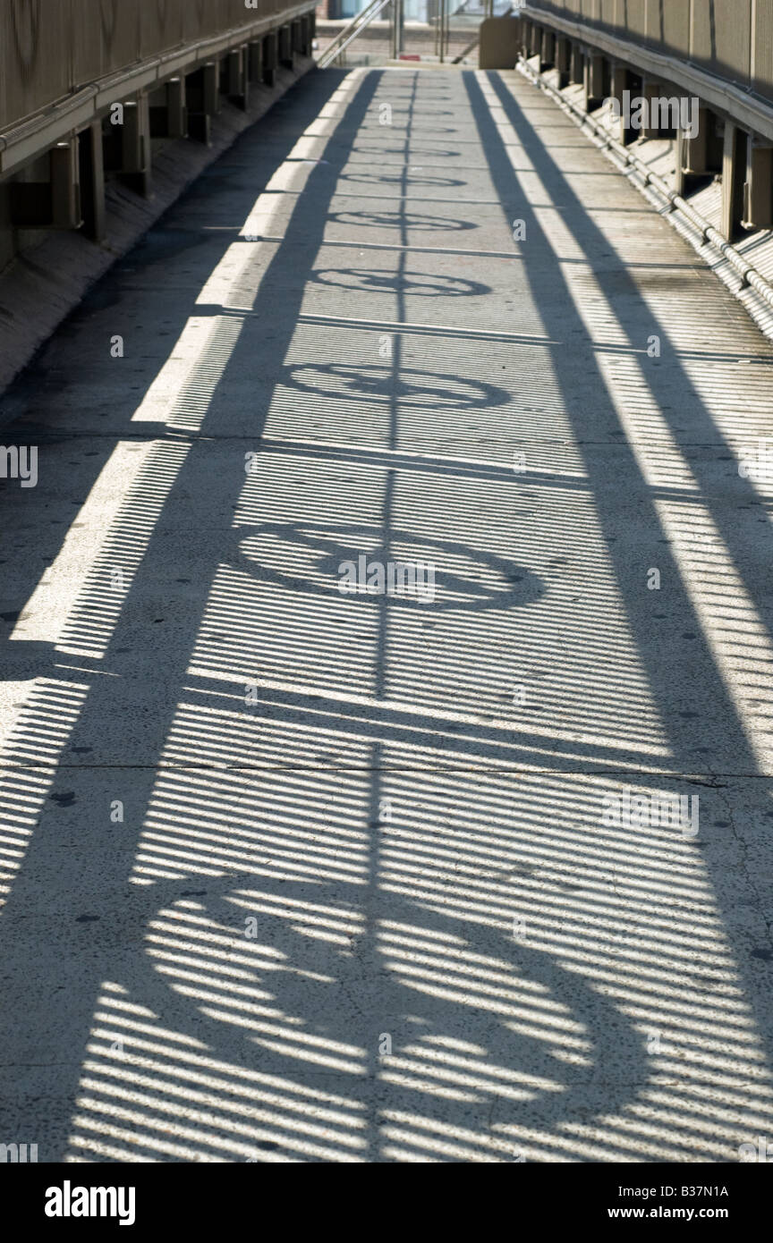 Shadows on pedestrian bridge Stock Photo - Alamy