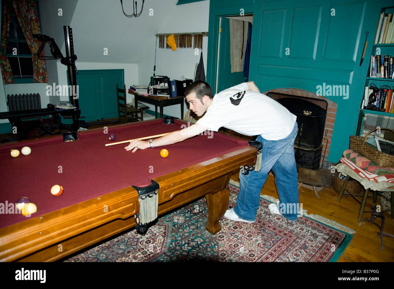 Young man playing pool Stock Photo - Alamy