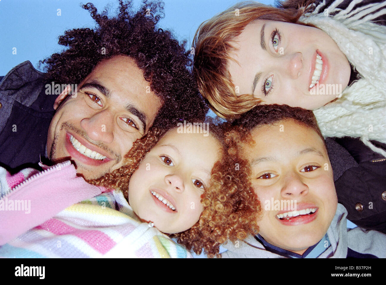 Portrait of young mixed race family taken from unusual angle with wide ...